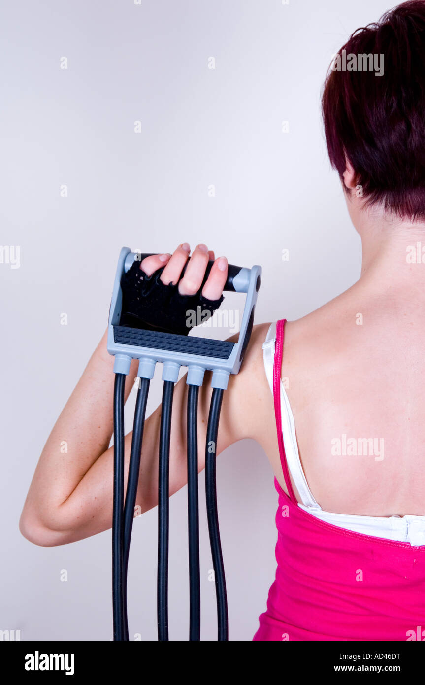 Woman exercising with chest expander Stock Photo - Alamy