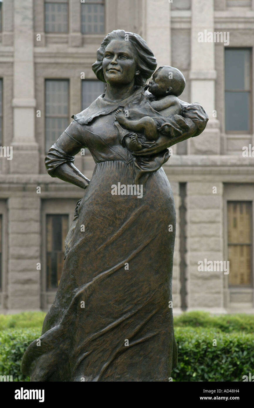 Bronze statue of a woman carrying her child outside the Texas State ...