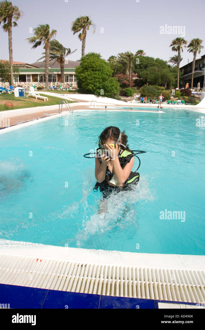 Female diver jumping into a pool with diving equipment, Fuerteventura ...
