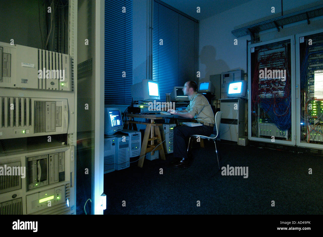 Technician in a computer room, data center Stock Photo - Alamy