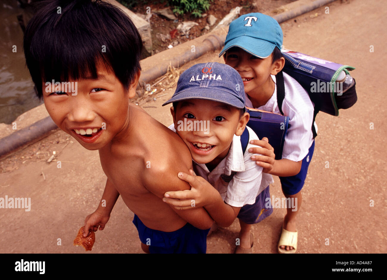 Children hiding behind one another while posing for the camera Vietnam ...