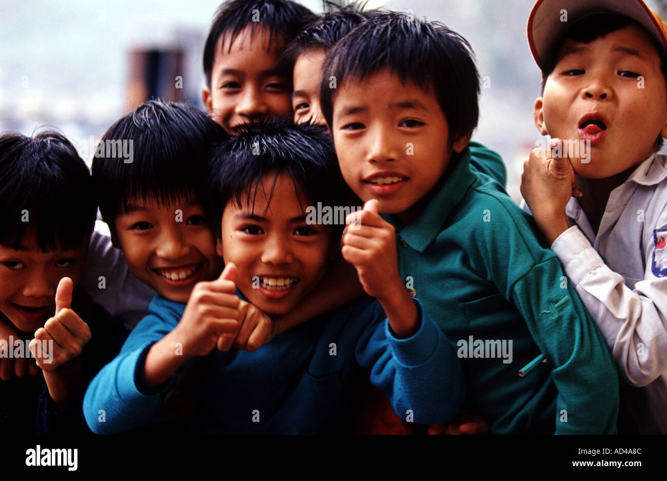 Children hiding behind one another while posing for the camera Vietnam ...