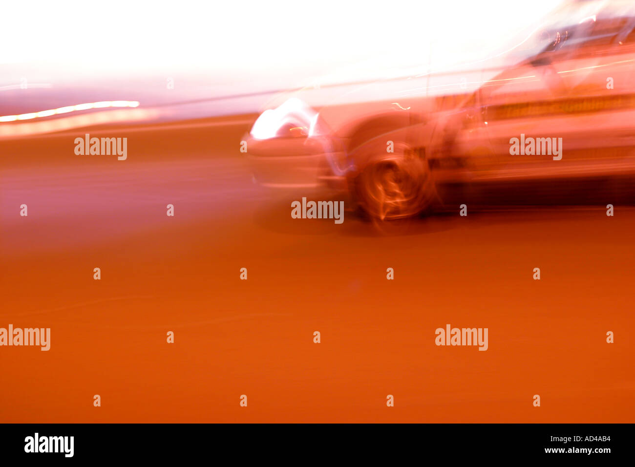 Taxi moving fast past the camera on a well lit street with evident ...