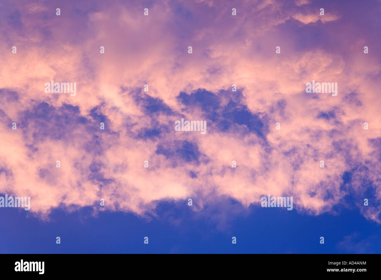 Luminous clouds on a sunset sky Stock Photo - Alamy