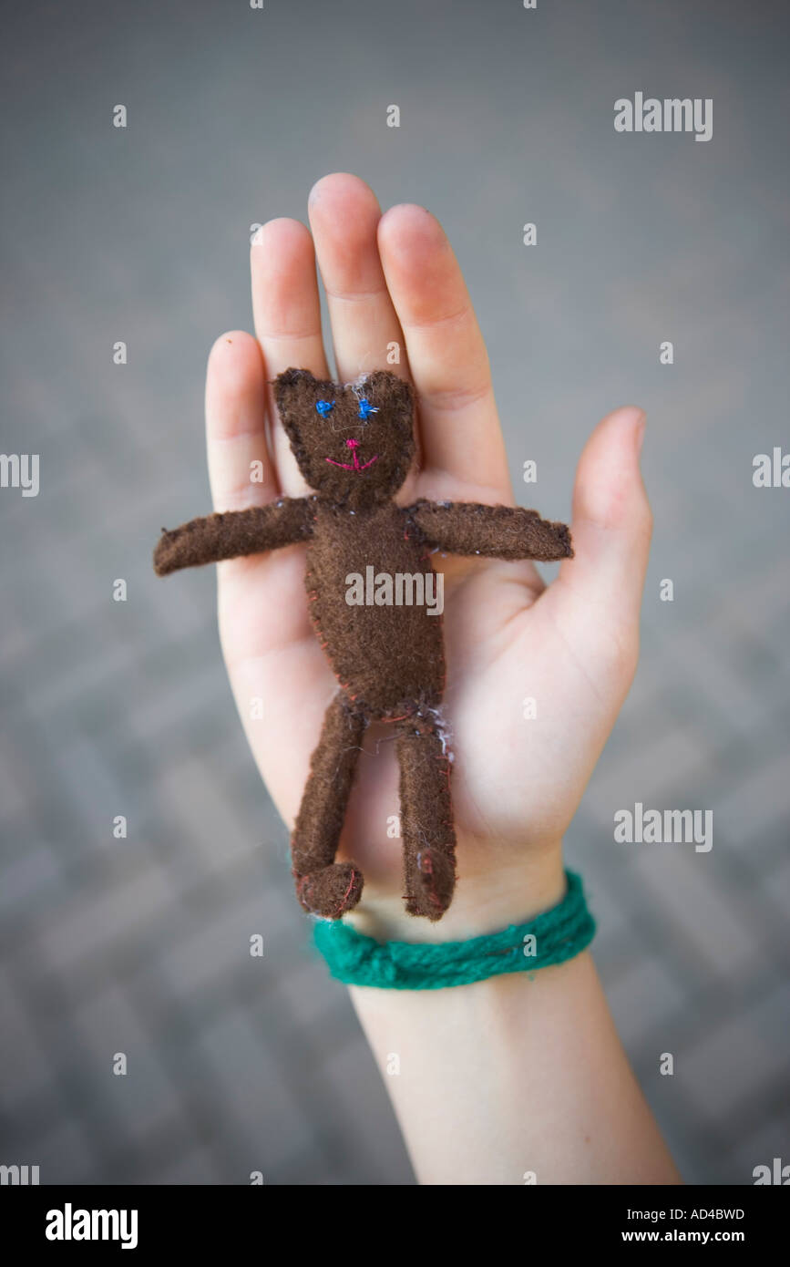 CHILD'S HAND HOLDING SMALL TINY BROWN FELT TEDDY BEAR Stock Photo - Alamy