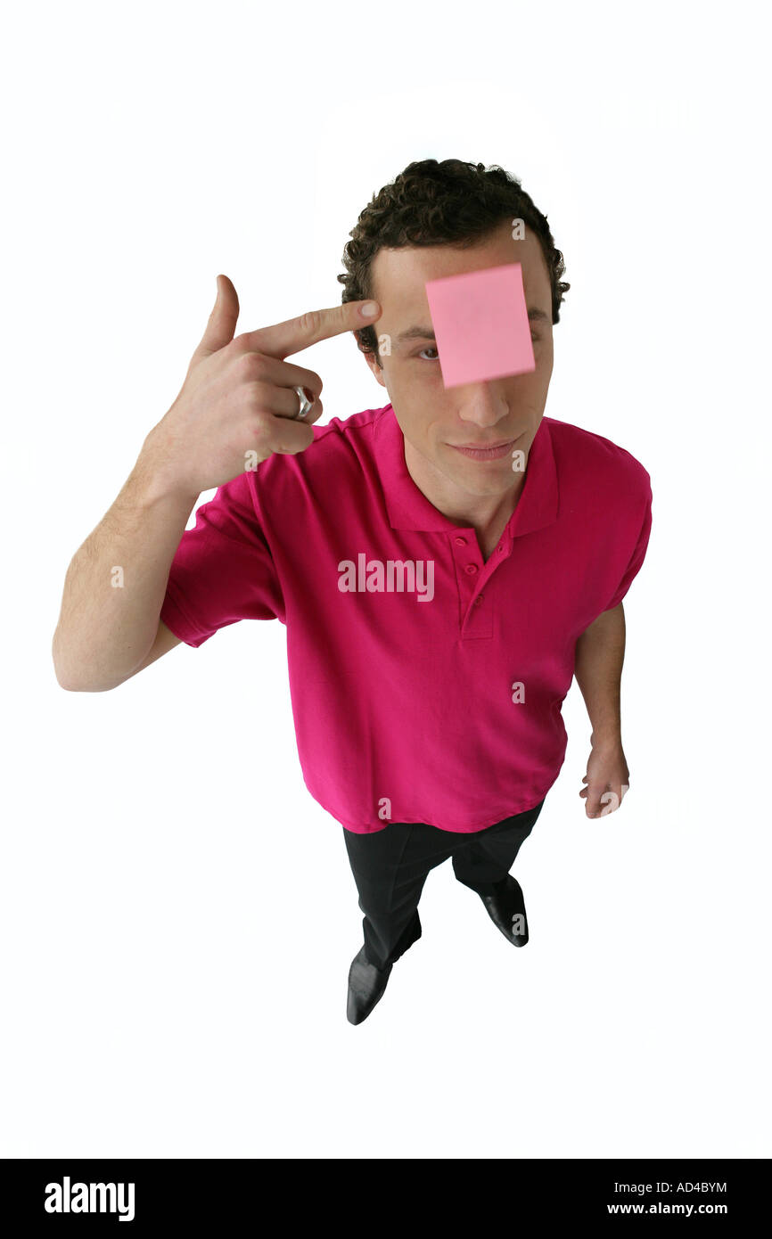 Young man having a post it stuck to his forehead Stock Photo - Alamy