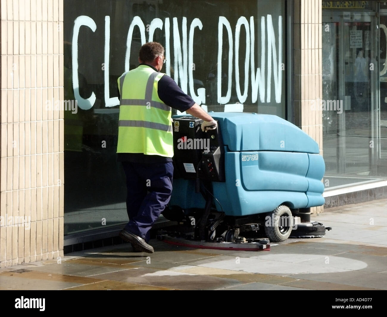 Colchester High Street pavement cleaning operative with mechanical ...