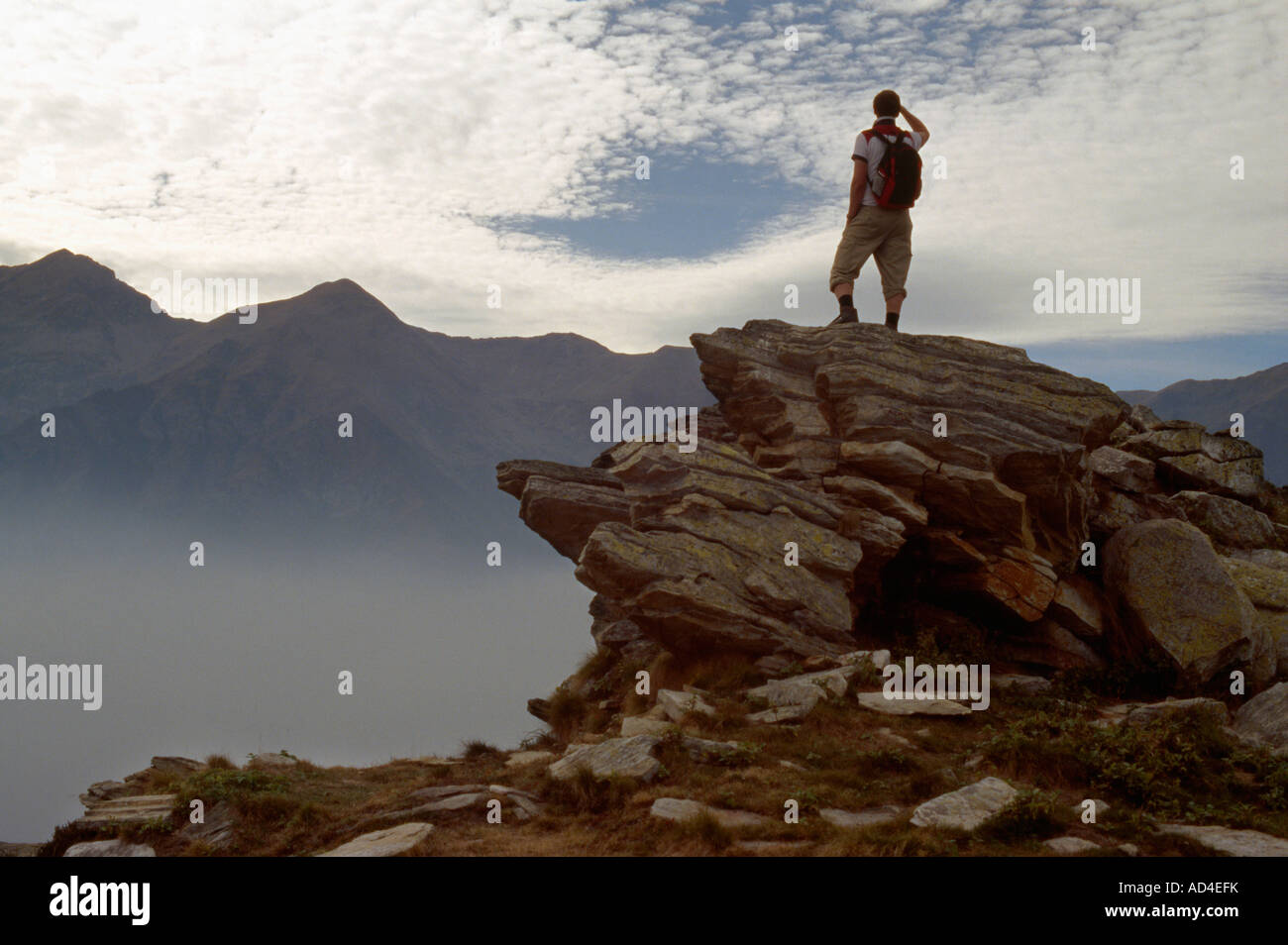 Man standing on cliff ledge hi-res stock photography and images - Alamy
