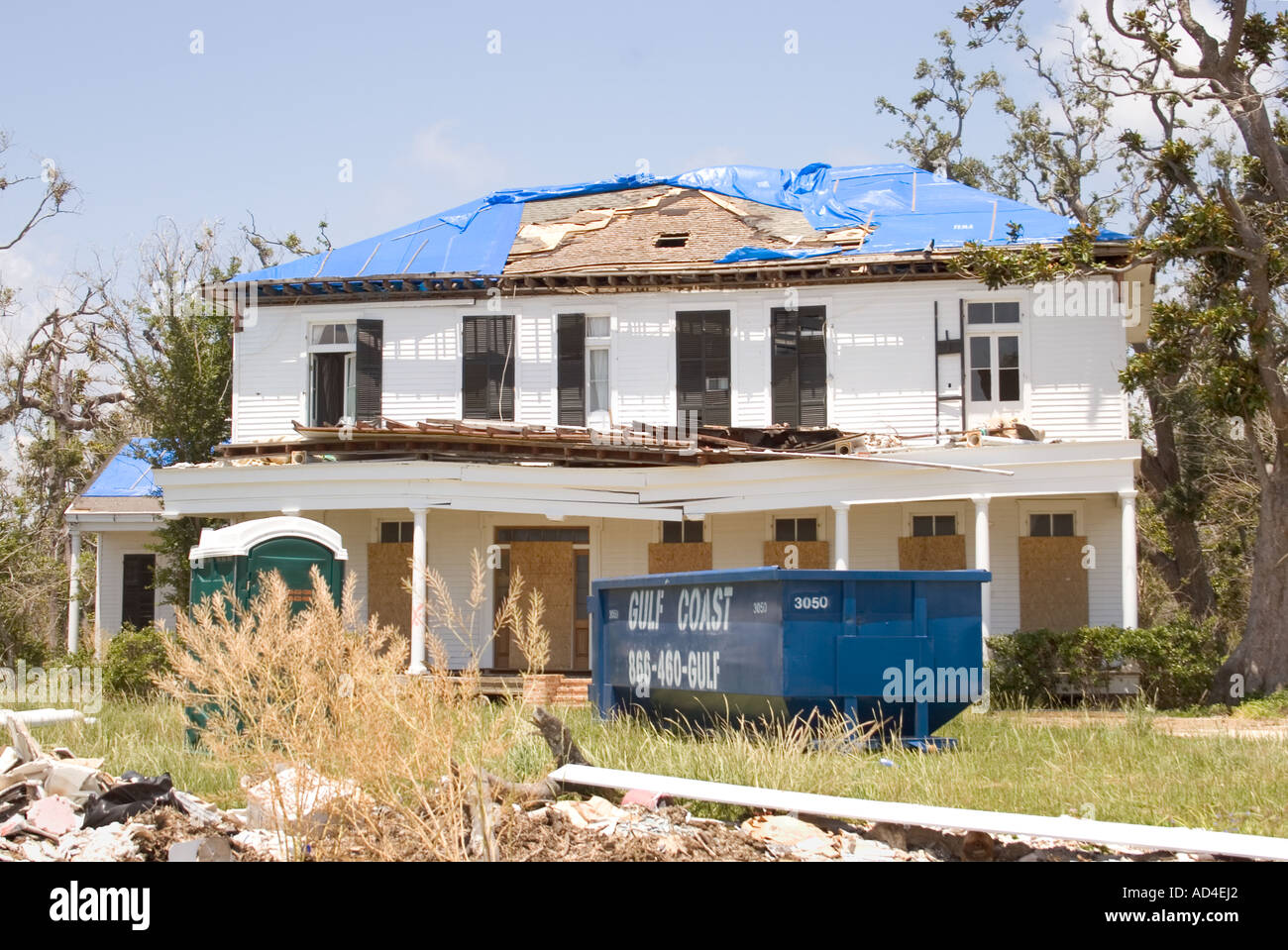 Temporary blue tarp roof to protect home from further damage, eight ...