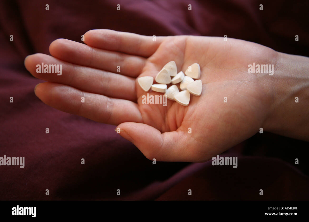 Triangle shaped white ecstasy tablets Stock Photo - Alamy