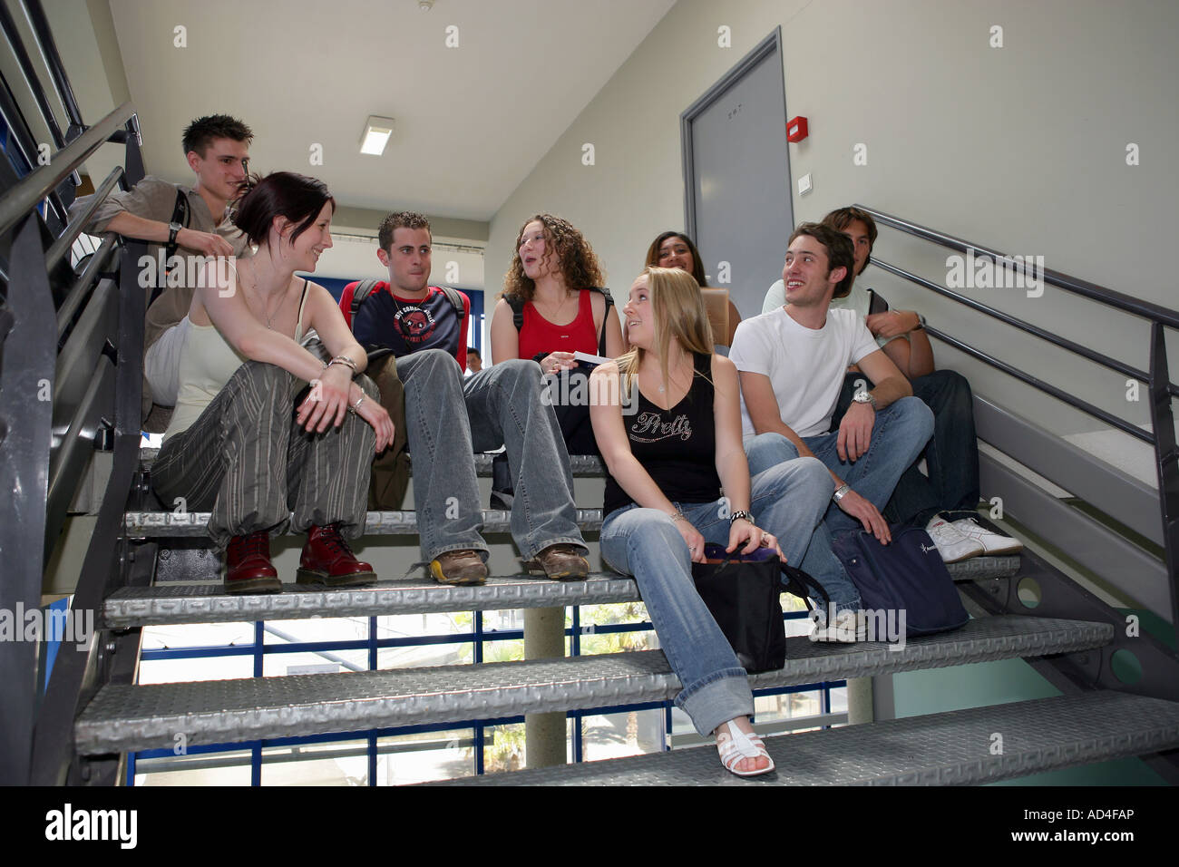 Students sitting on some stairs Stock Photo - Alamy