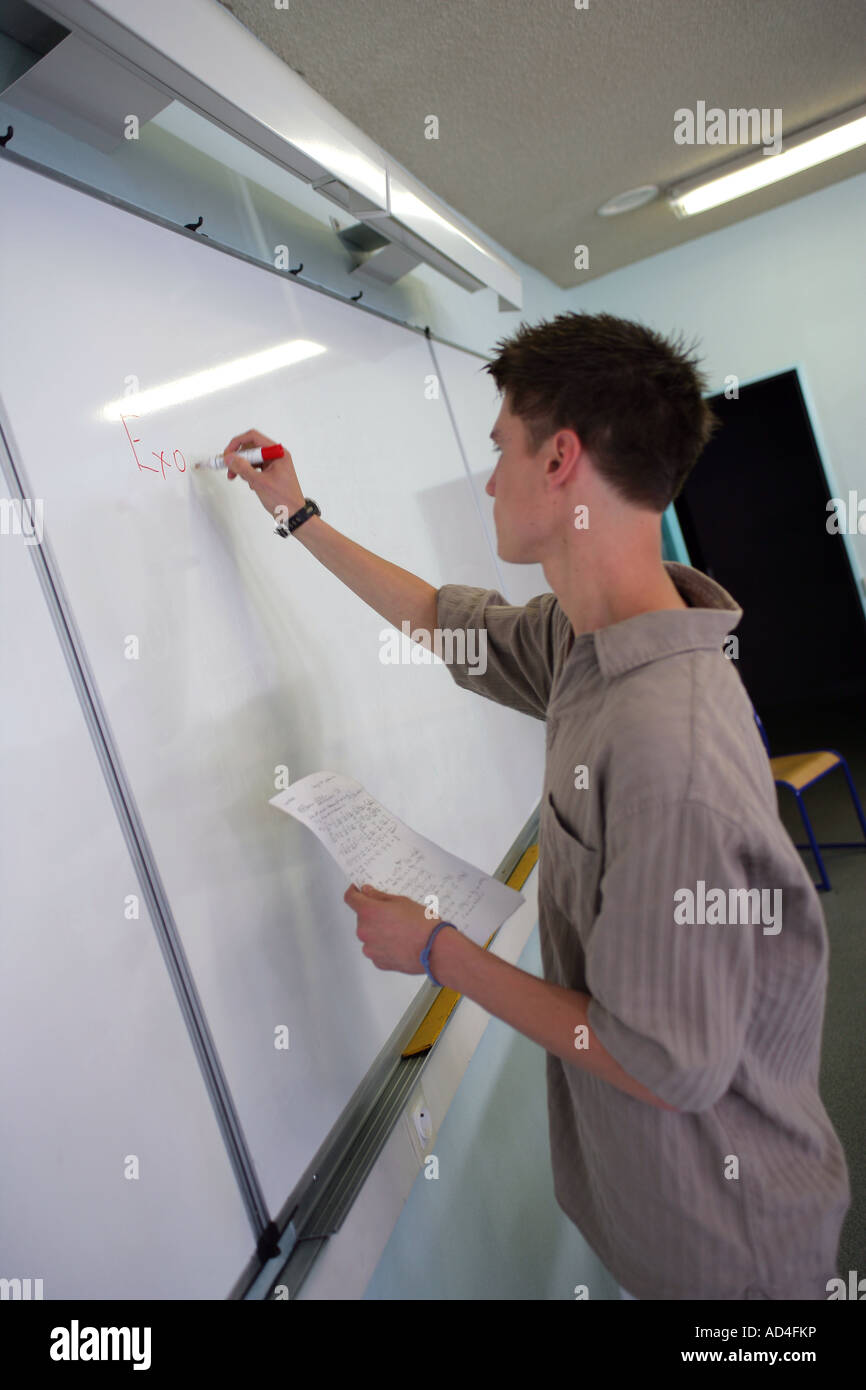 Student writing on a board Stock Photo - Alamy
