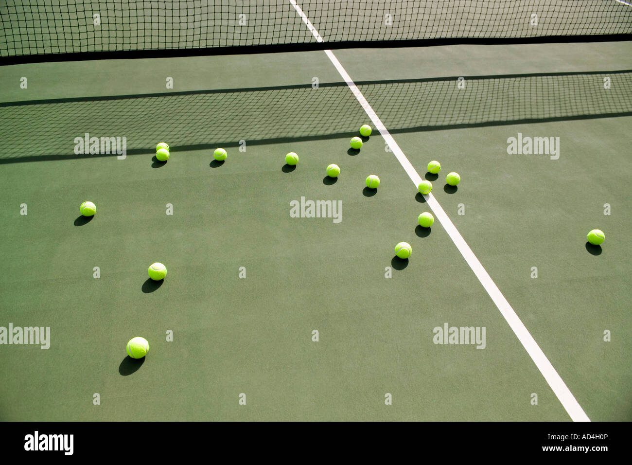 Tennis balls scattered on a tennis court Stock Photo - Alamy