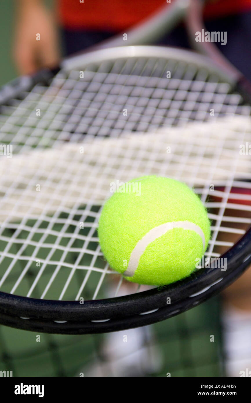 A tennis ball balancing on a tennis racquet Stock Photo - Alamy