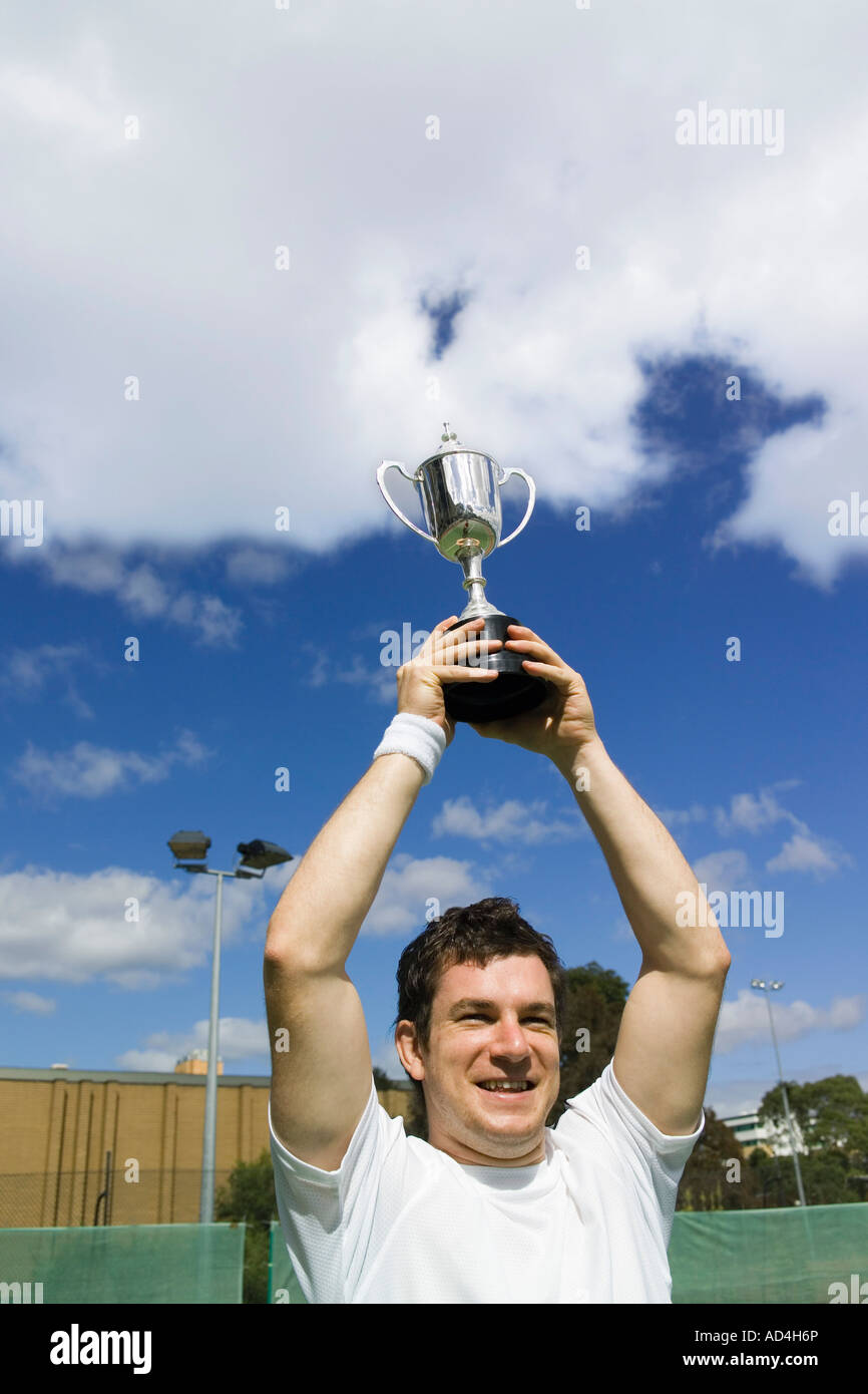 A tennis player lifting a trophy Stock Photo - Alamy