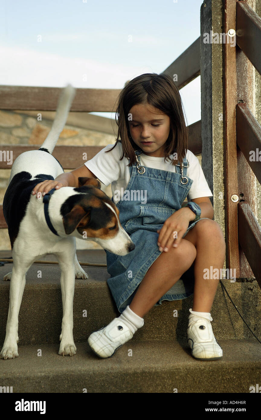 Little girl caressing a dog Stock Photo - Alamy
