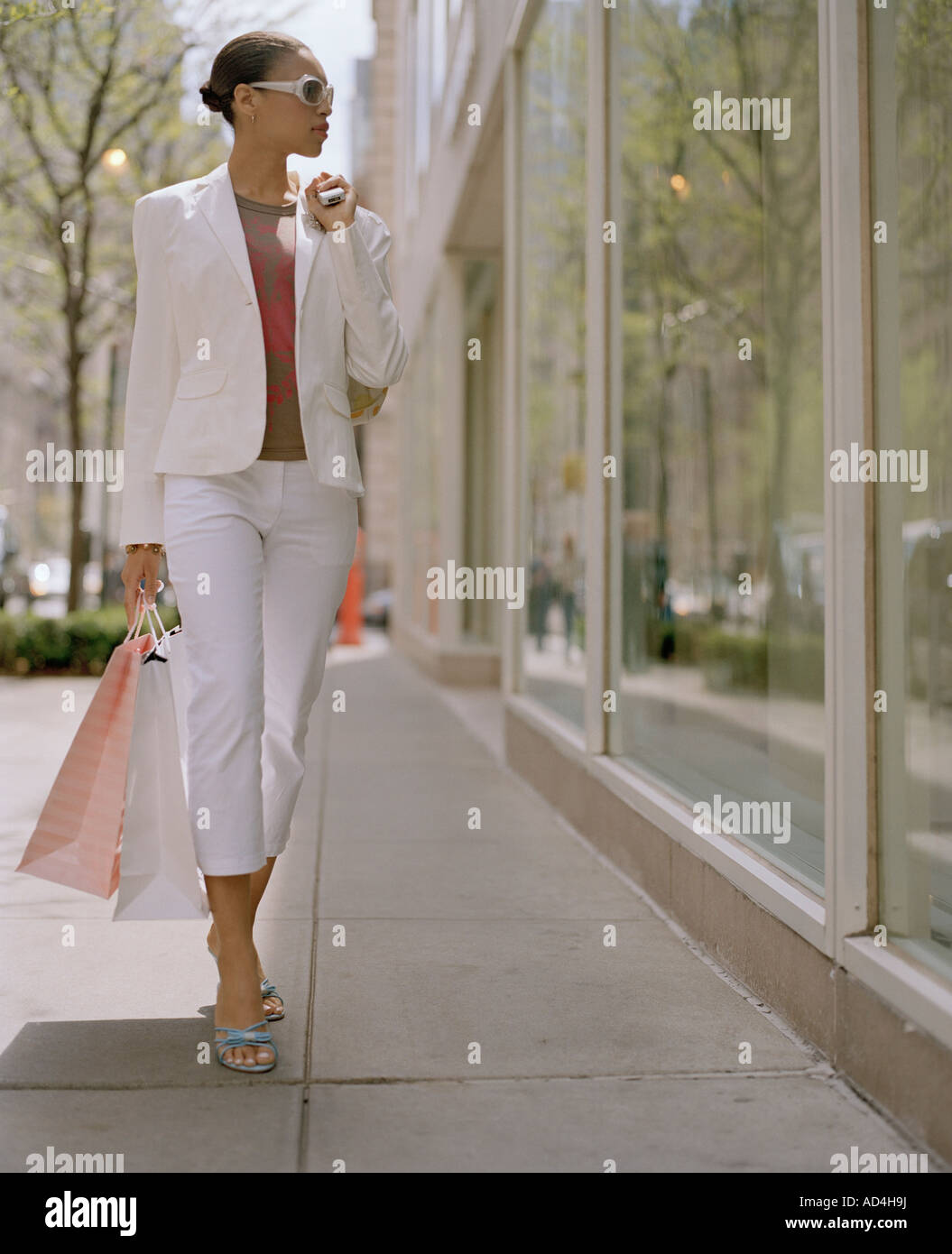 Woman carrying shopping bags and looking into a shop window Stock Photo ...