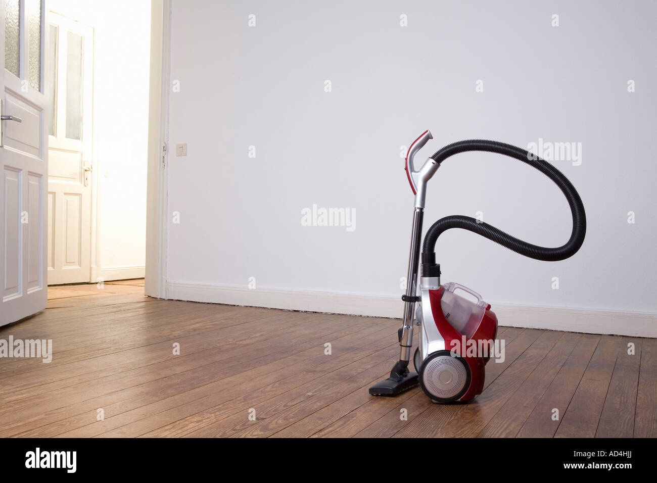 Vacuum cleaner in an empty room Stock Photo - Alamy