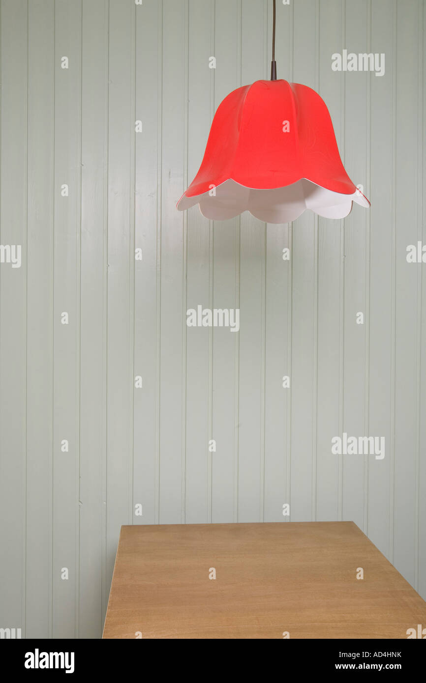 Lamp shade hanging above a wooden table Stock Photo - Alamy