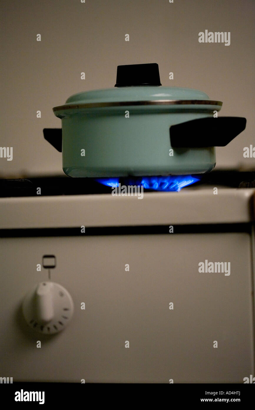A saucepan on a lit stove Stock Photo - Alamy