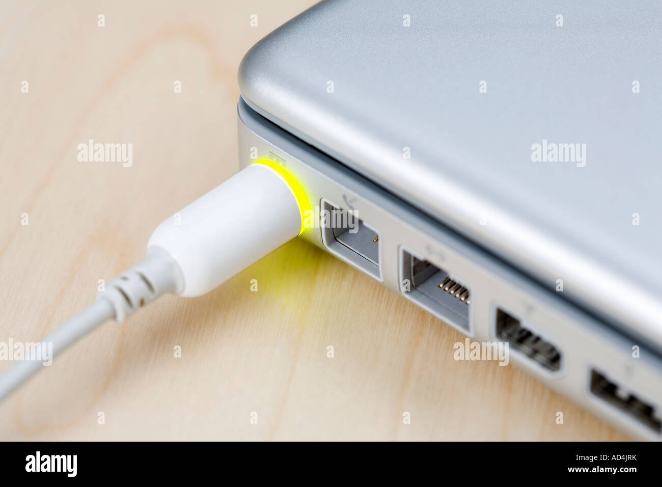 A power cable connected to a closed laptop Stock Photo - Alamy