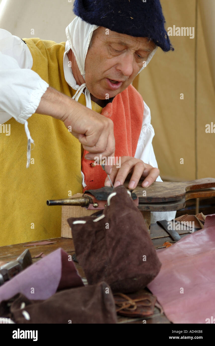 Old man in medieval costume repairing a bellows blower Stock Photo - Alamy