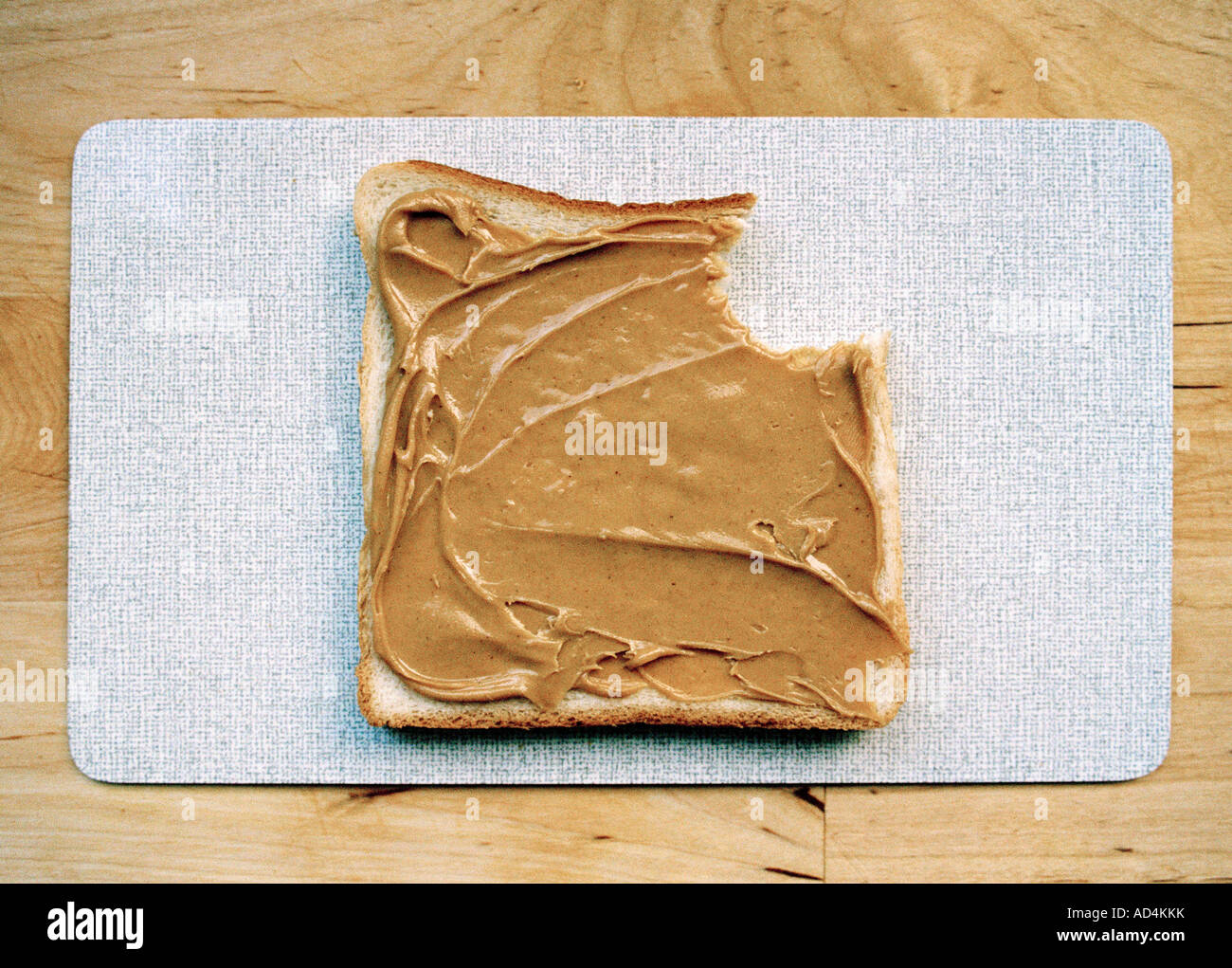 A missing bite from a slice of bread with peanut butter Stock Photo - Alamy