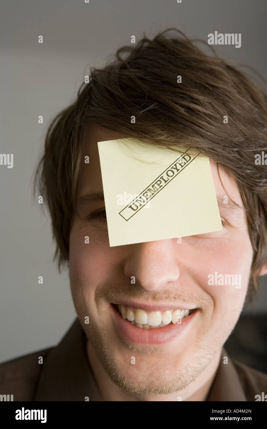 A man with an adhesive note on his forehead stamped 'Unemployed' Stock ...