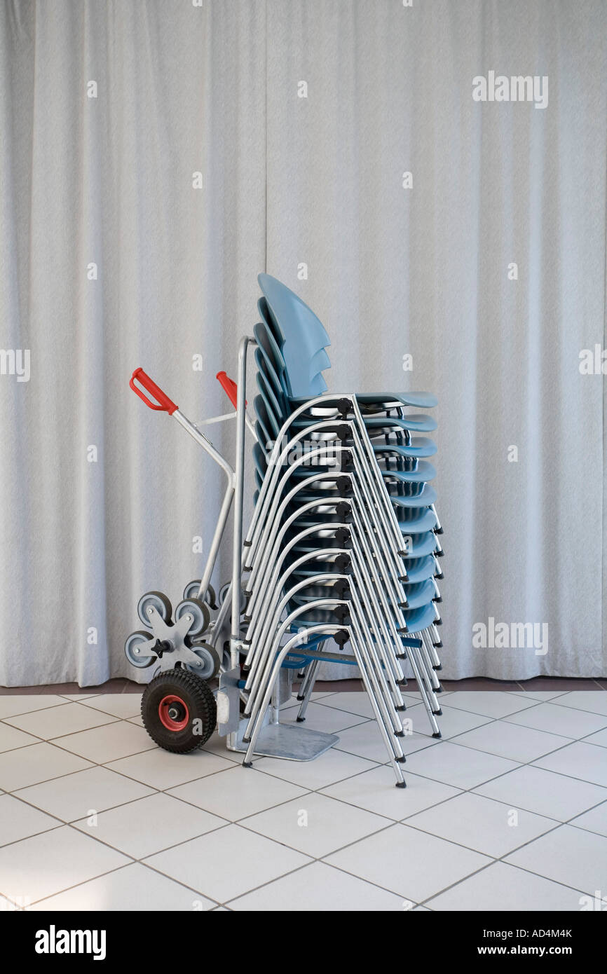 Stacked chairs on a sack barrow Stock Photo - Alamy