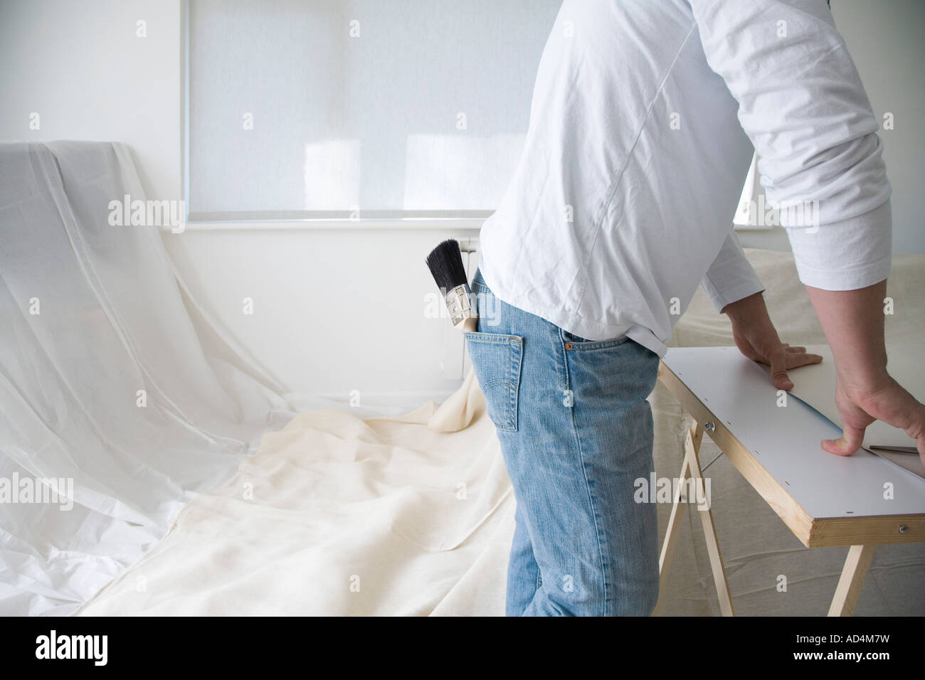 A man standing next to a decorating table Stock Photo - Alamy
