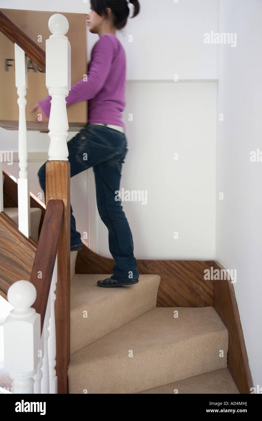 Woman moving box steps hi-res stock photography and images - Alamy