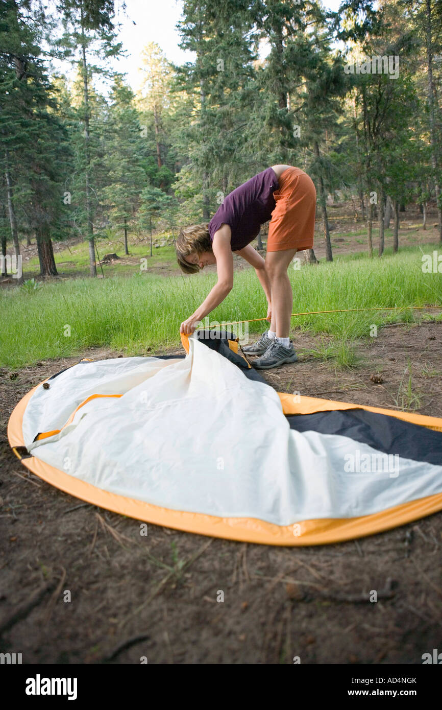 A woman setting up a tent Stock Photo - Alamy