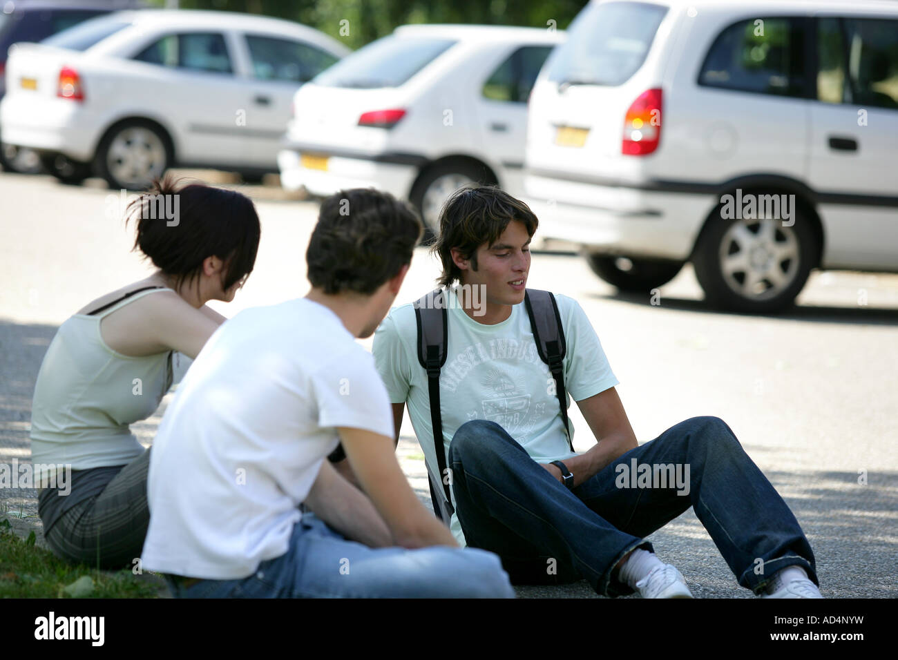 Students sitting on the ground Stock Photo - Alamy