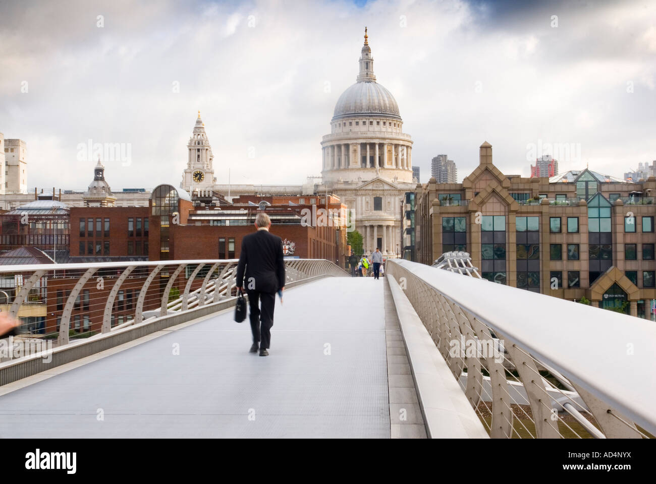 Lone Commuter walking across Millennium bridge into City of London ...