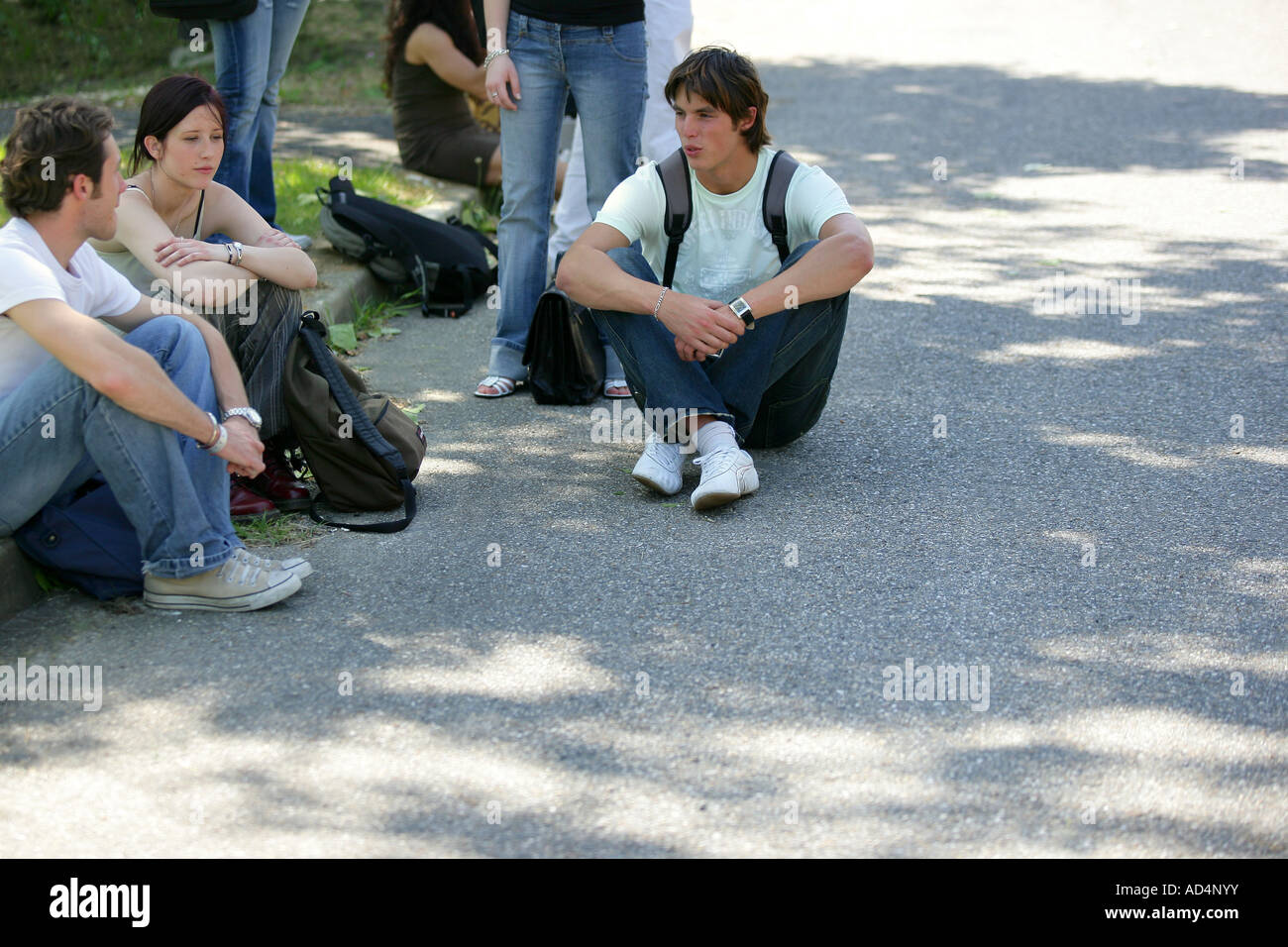 Students sitting on the ground Stock Photo - Alamy