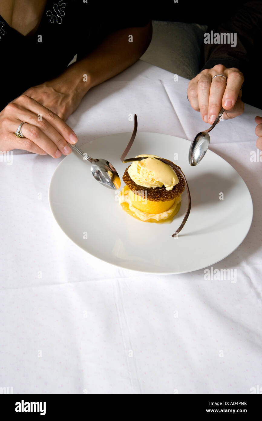 A couple sharing a dessert in a restaurant Stock Photo - Alamy