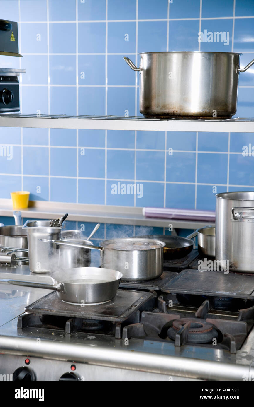 Pans cooking on a stove Stock Photo - Alamy