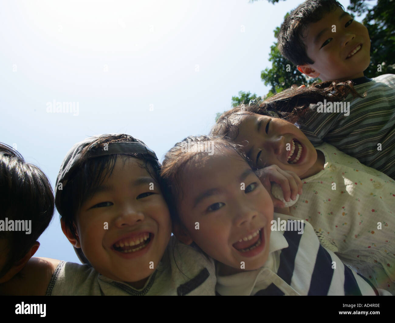 Low angle view of a group of children smiling Stock Photo - Alamy