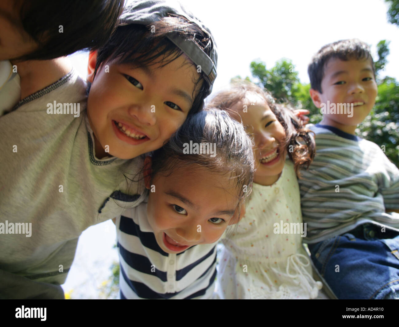 Low angle view of a group of children smiling Stock Photo - Alamy