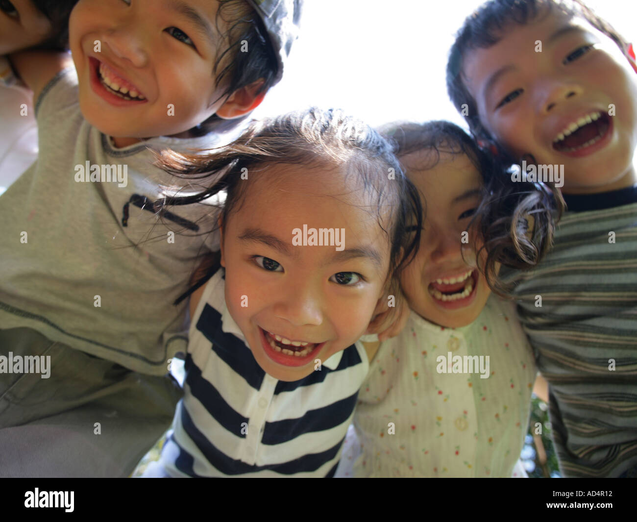 Low angle view of a group of children laughing Stock Photo - Alamy