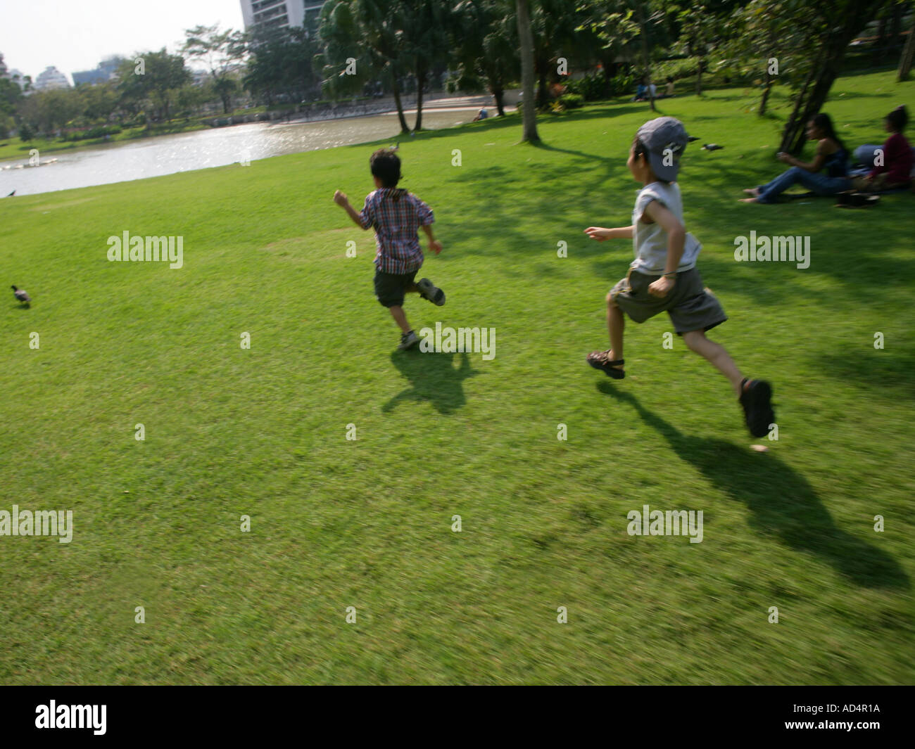 Rear view of two boys running in a park Stock Photo - Alamy