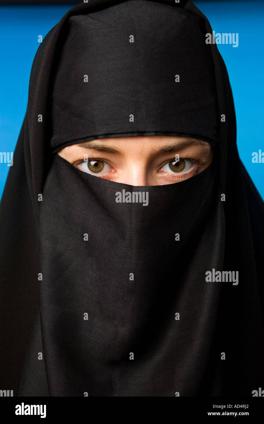 Close up head shot of a Muslim woman in a black hijab with eyes looking ...