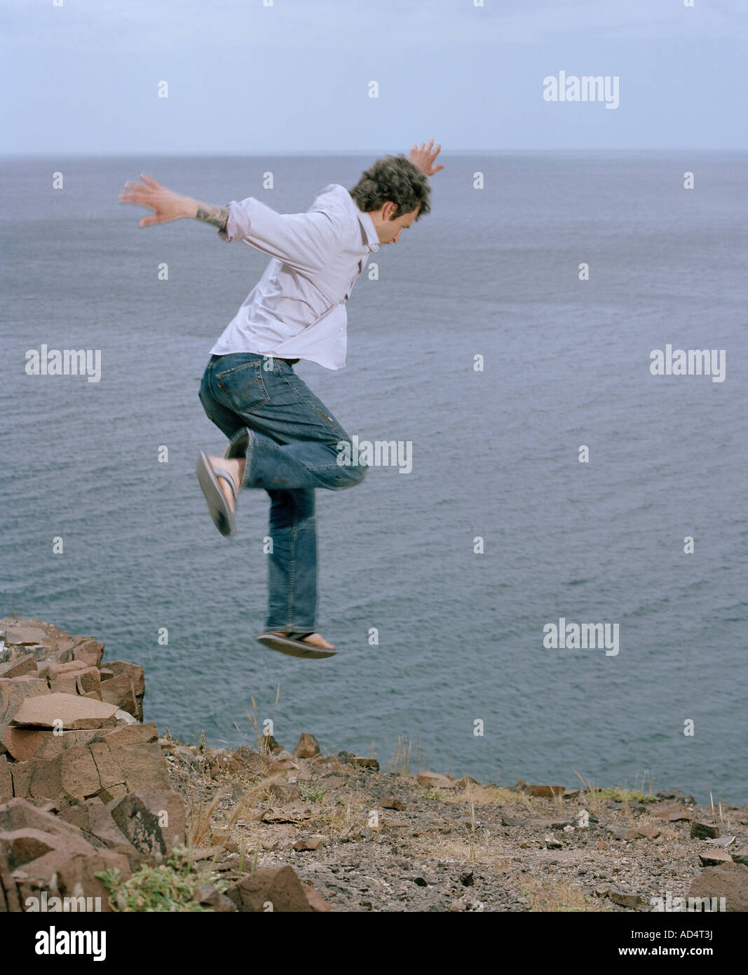 Man jumping off cliff sea hi-res stock photography and images - Alamy