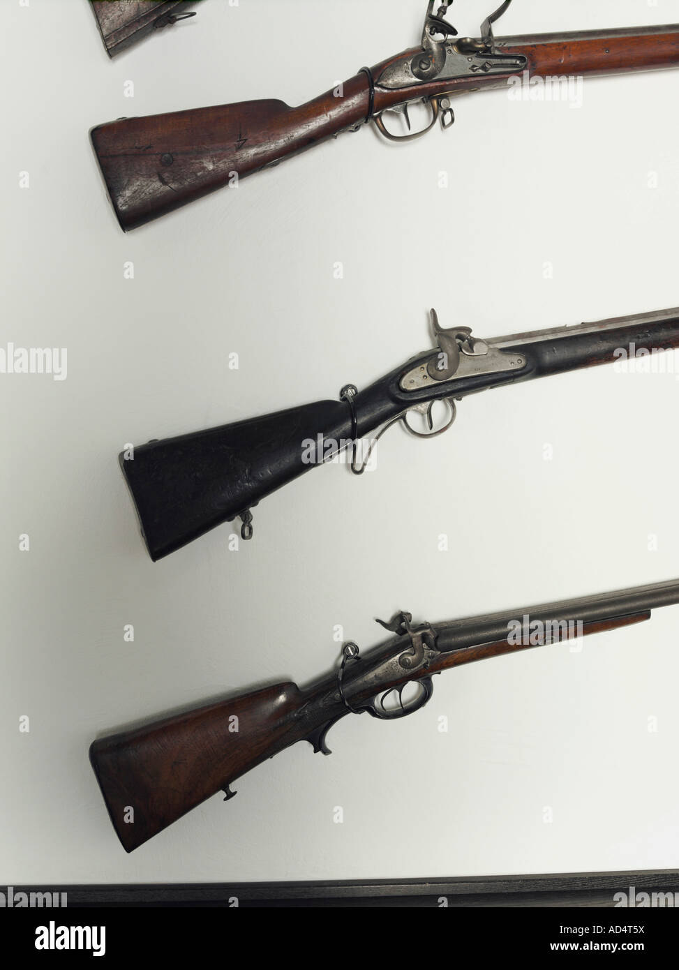 A collection of rifles on a wall Stock Photo - Alamy