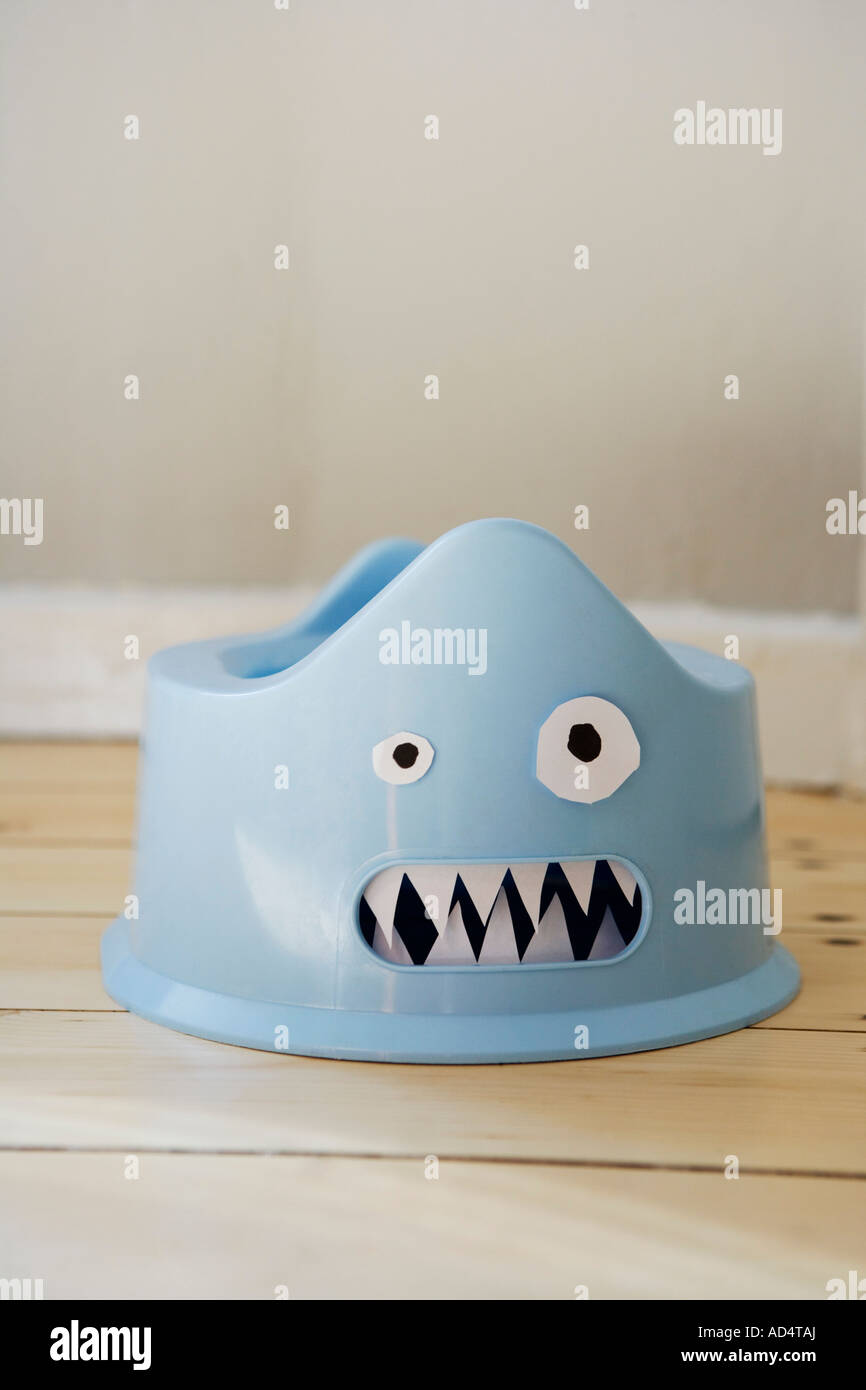 A plastic potty with a cardboard face Stock Photo - Alamy