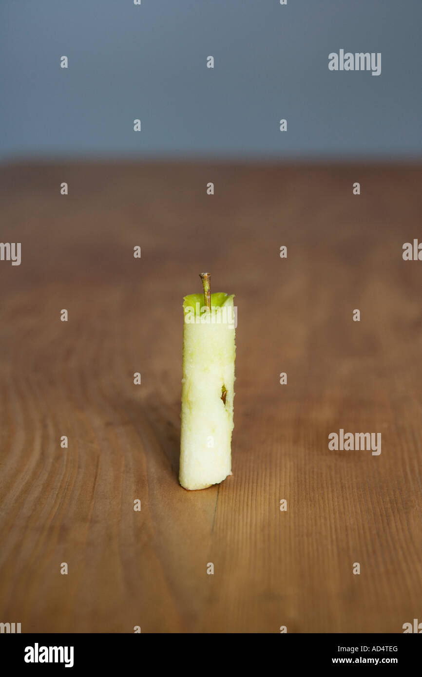 Apple core on a wooden table Stock Photo - Alamy