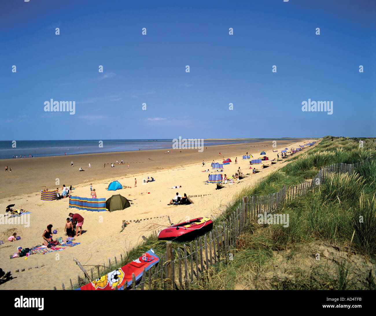 long golden sand beach backed by dunes overlooking the shallow ...