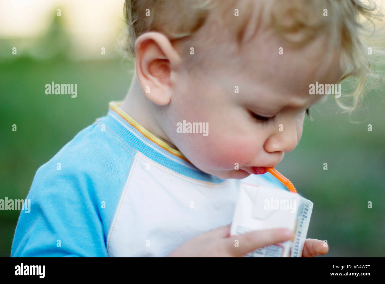 A young boy holding a juice box Stock Photo - Alamy