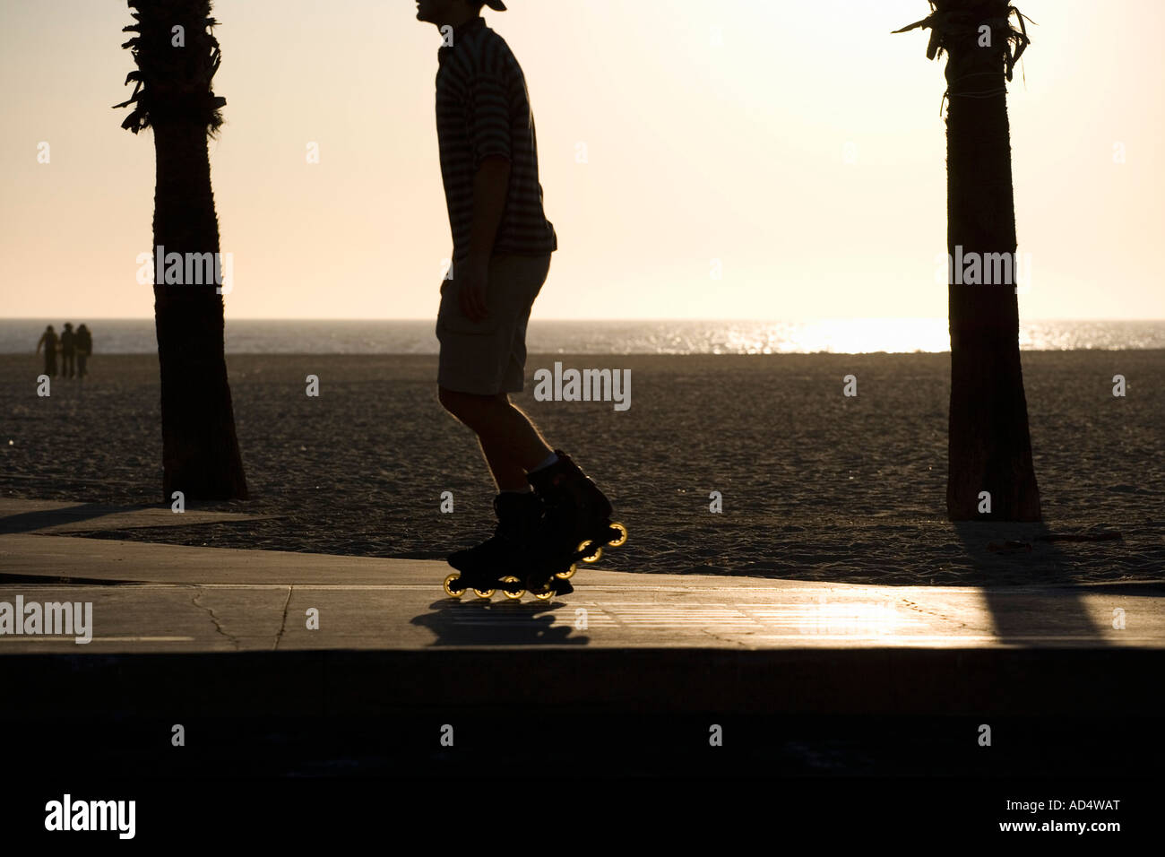 A rollerblader at the beach at sunset Stock Photo - Alamy