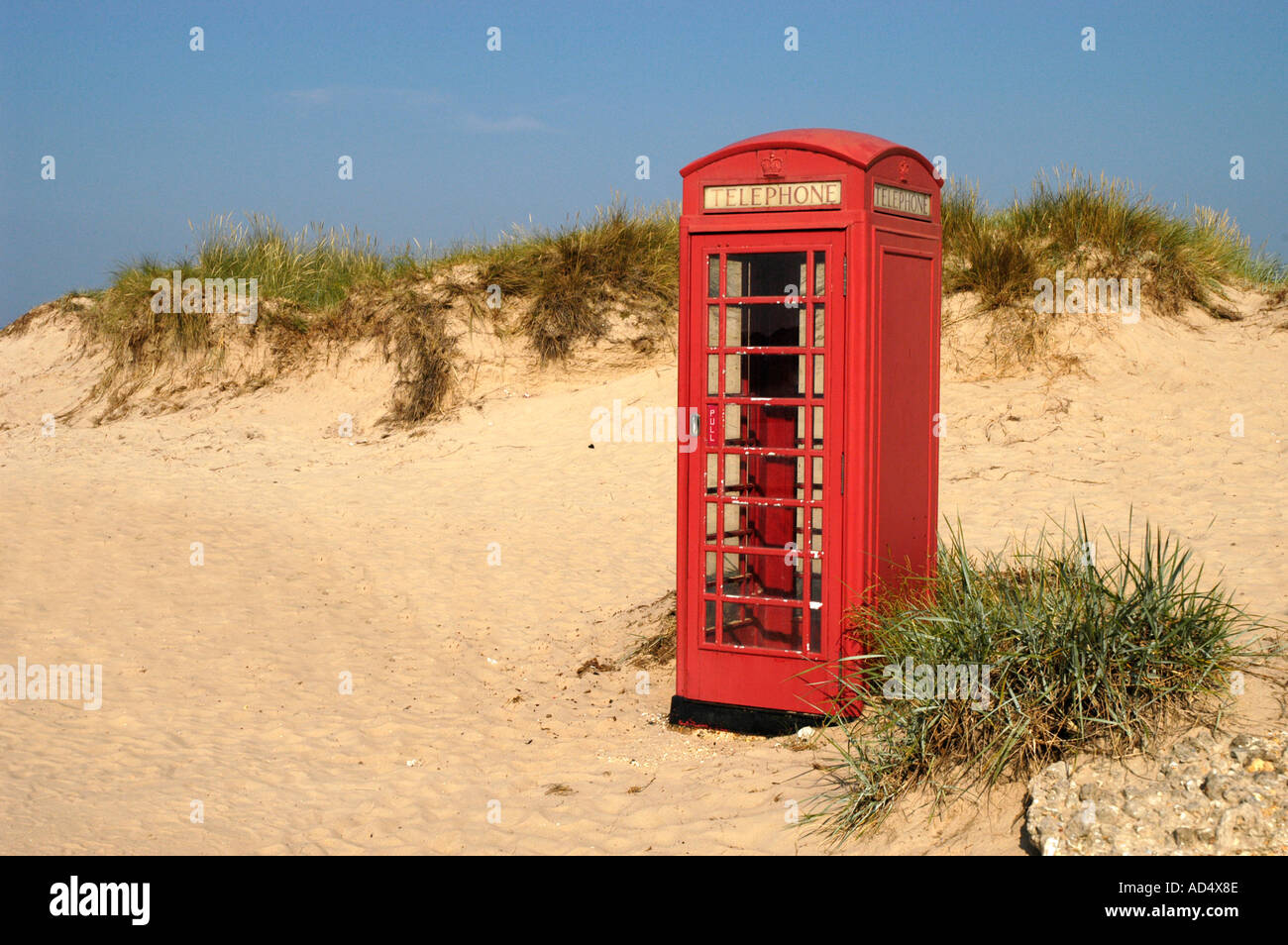 Traditional English telephone box on yellow sandy beach at Sandbanks in ...